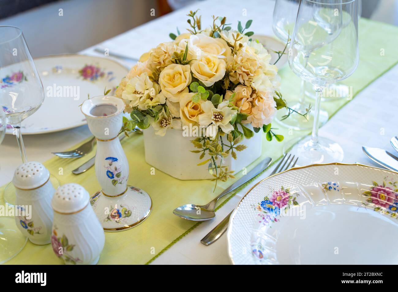 A table set with decorative porcelain cutlery and flowers Stock Photo ...