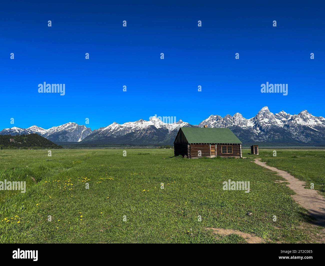 Jackson Hole, WY USA - June 5, 2023: A log cabin with the Teton ...