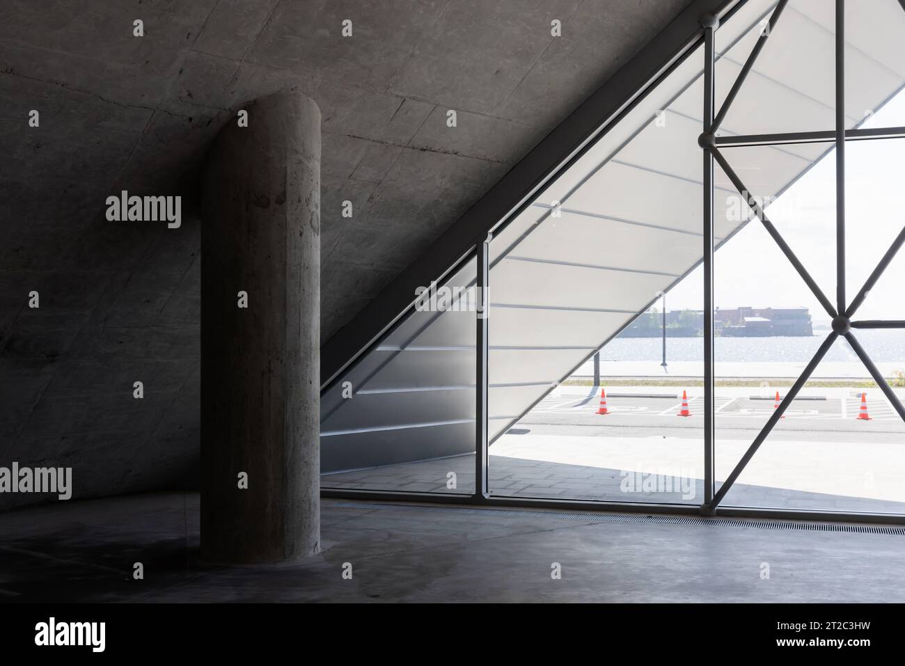 Abstract modern interior background with concrete pillar in front of a ...