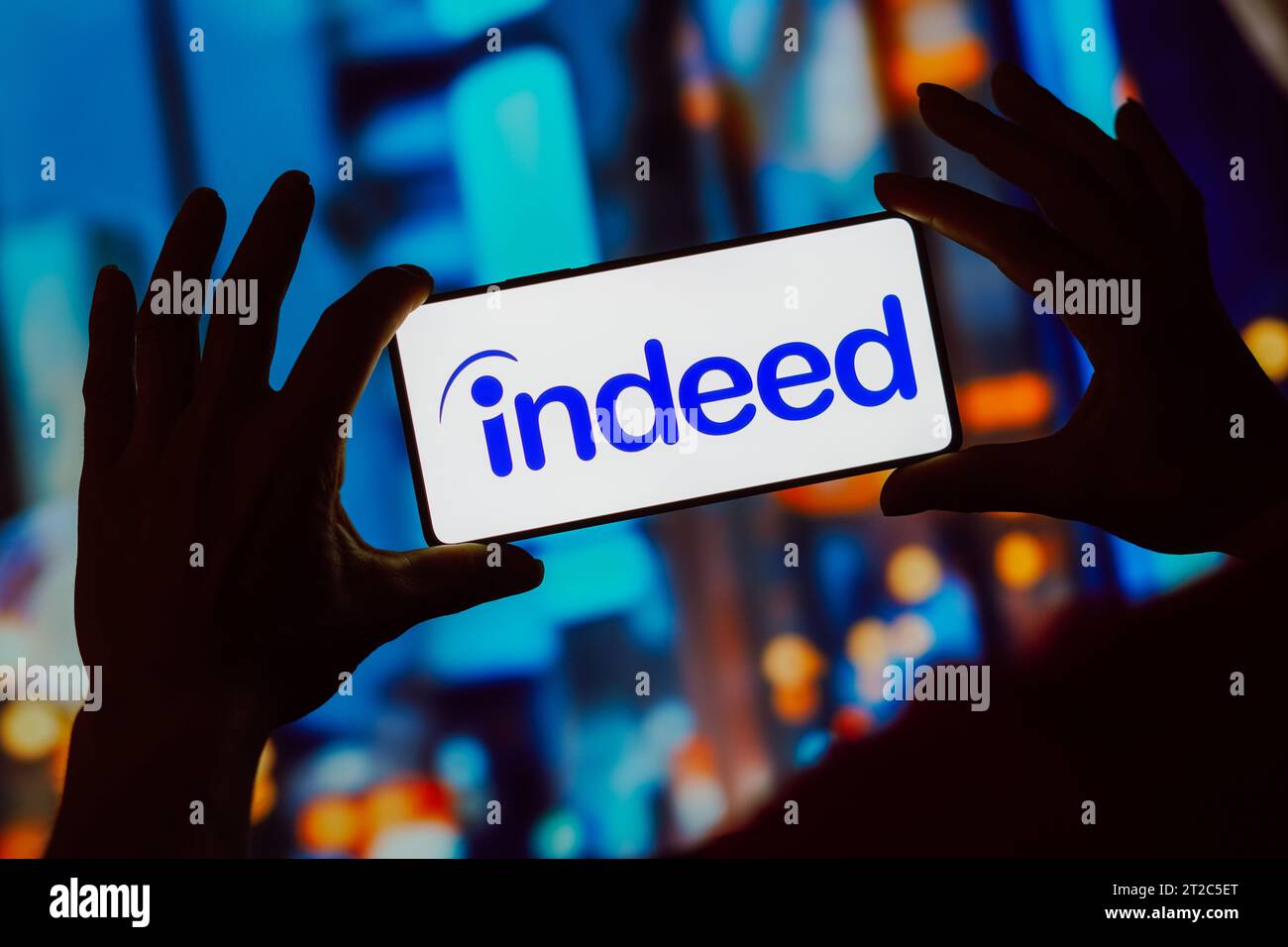 In this photo illustration, the Indeed logo is displayed on a smartphone screen Stock Photo - Alamy