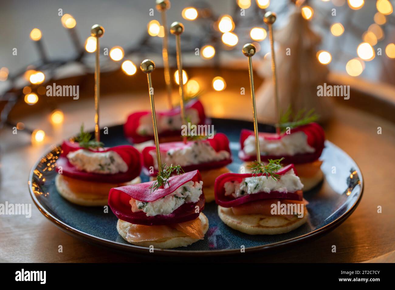 Christmas canapes with blinis with salmon, pickled beetroot and goat ...