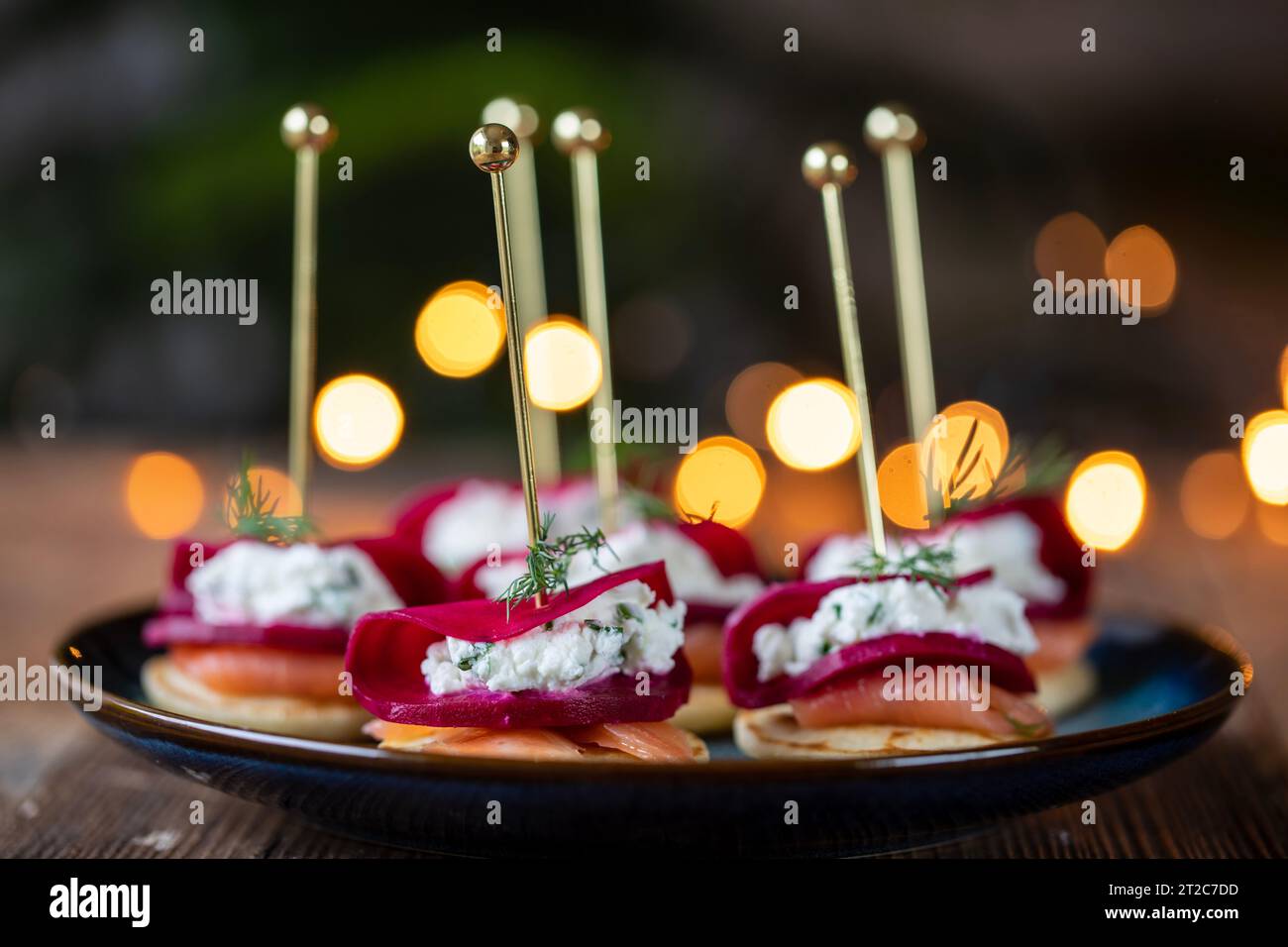 Christmas canapes with blinis with salmon, pickled beetroot and goat ...