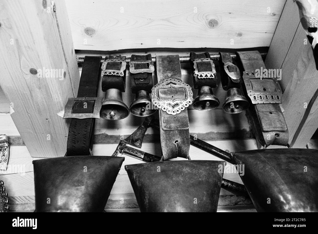 Vintage cow bells hung in traditional log house Stock Photo - Alamy