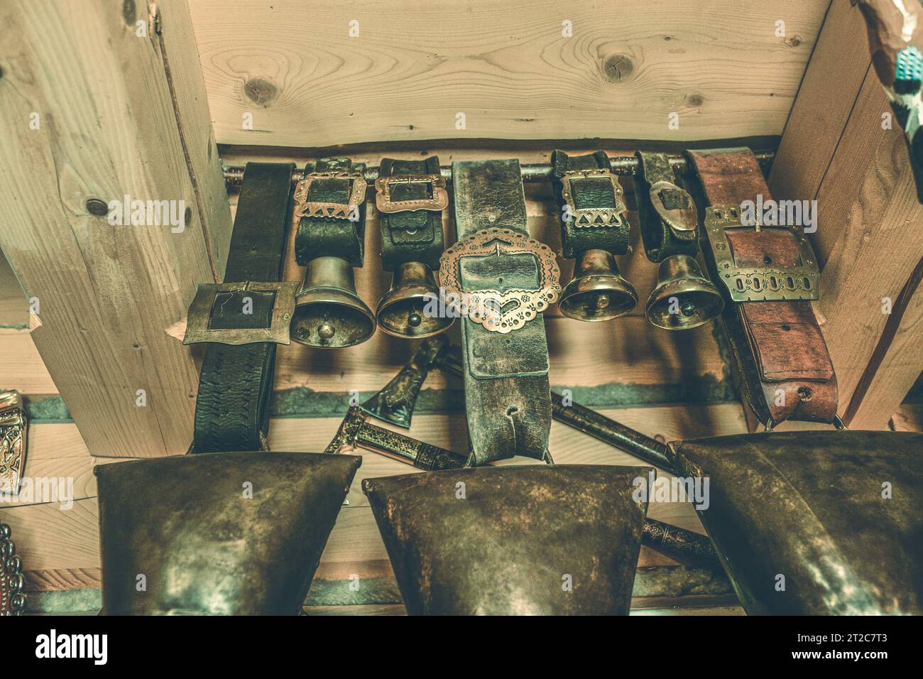 Vintage cow bells hung in traditional log house Stock Photo - Alamy