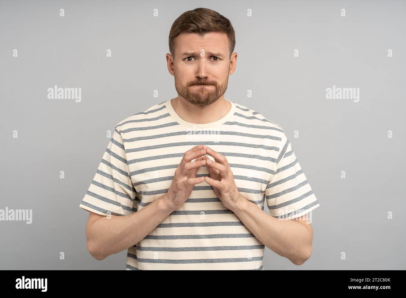 Agitated anxious man thinking about difficult problems looking at ...