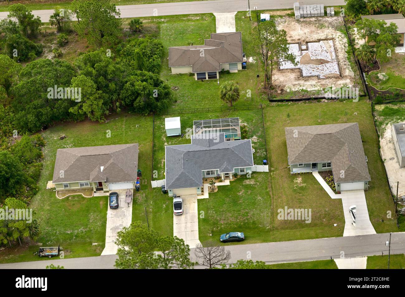 Aerial landscape view of suburban private houses between green palm ...