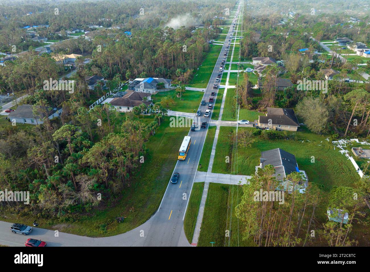 Aerial view of american yellow school bus picking up children at ...