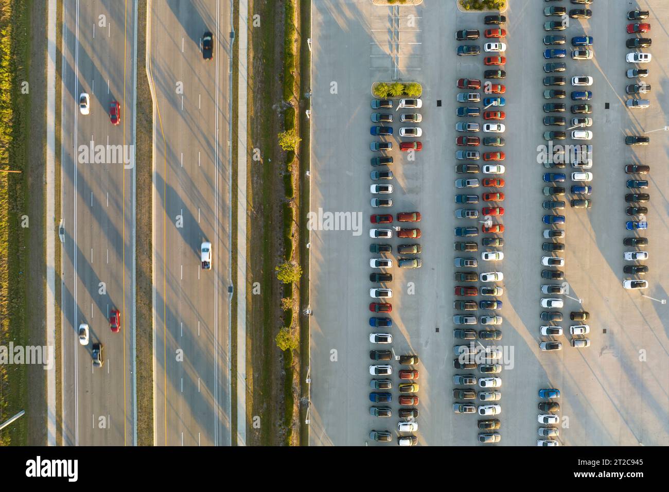 Aerial view of dealership parking lot with many brand new cars for sale ...