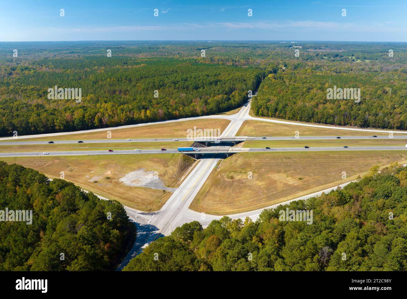 Aerial view of freeway overpass junction with fast moving traffic cars ...