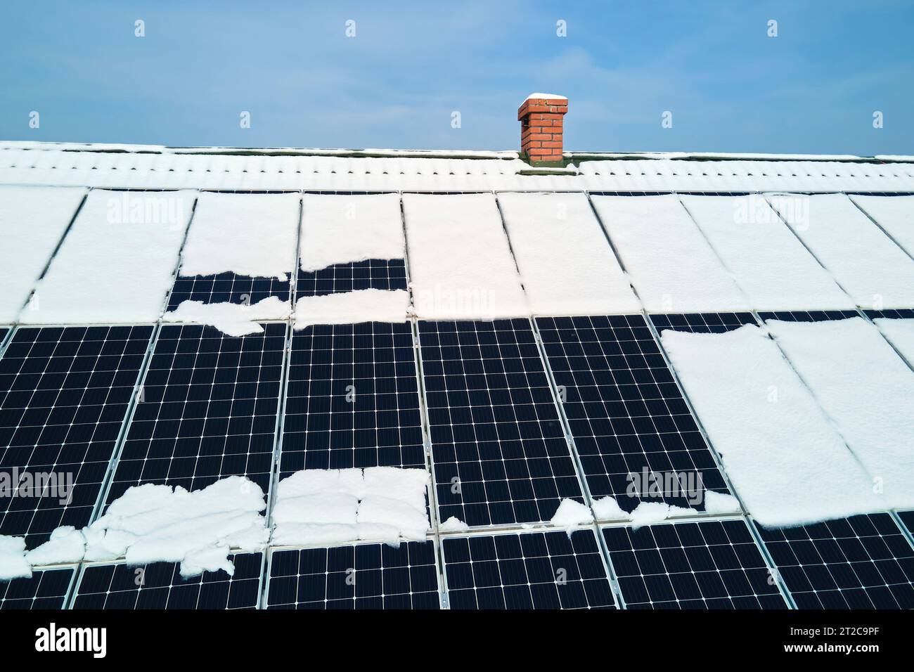Aerial view of snow melting from covered solar photovoltaic panels ...