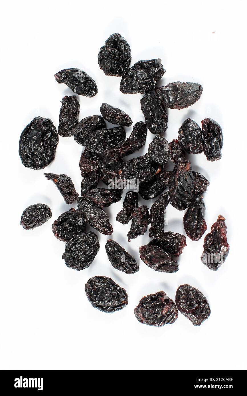 Dried raisins of different size on a white background Stock Photo - Alamy