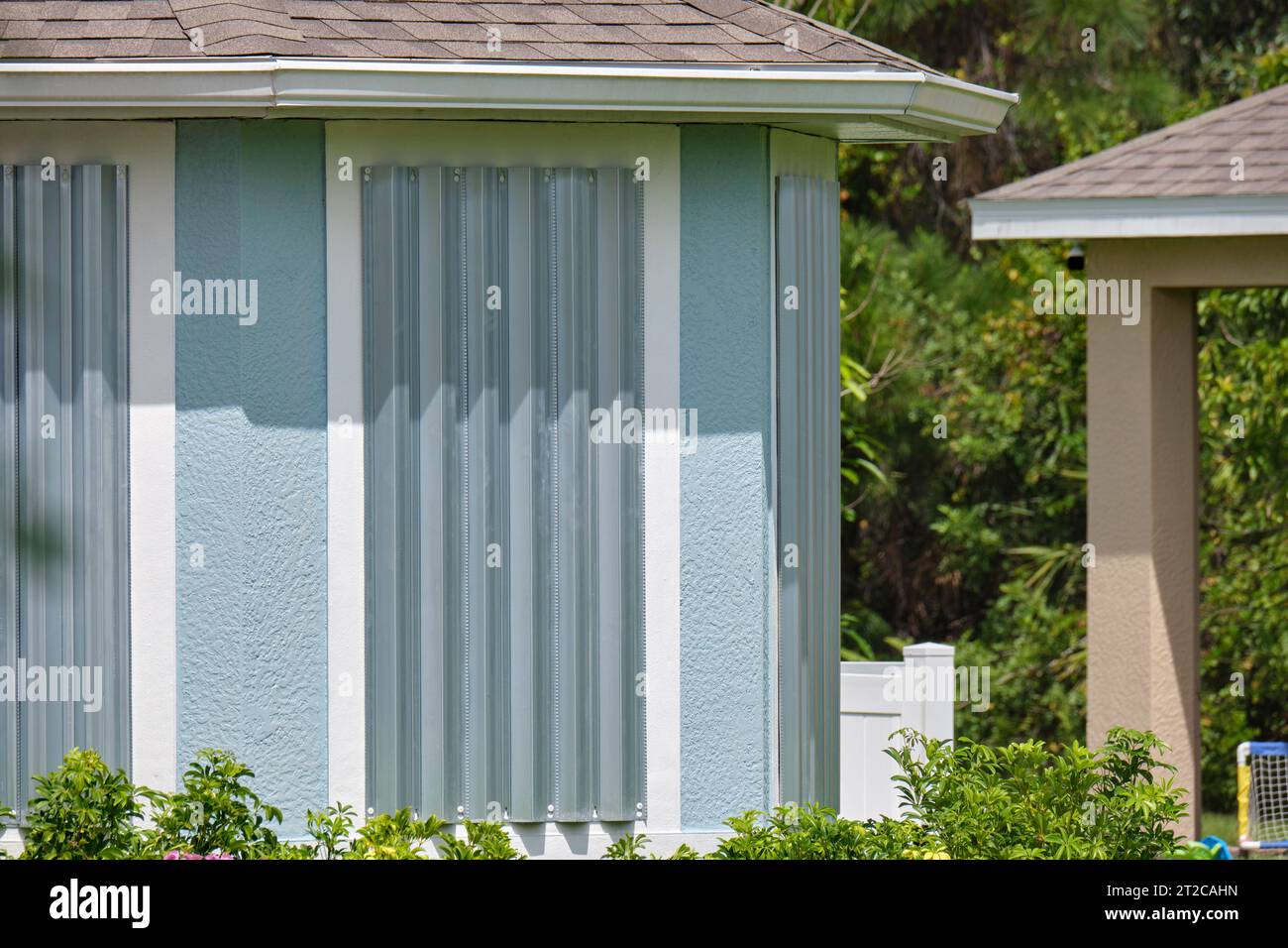 Boarded up windows with steel storm shutters for hurricane protection ...