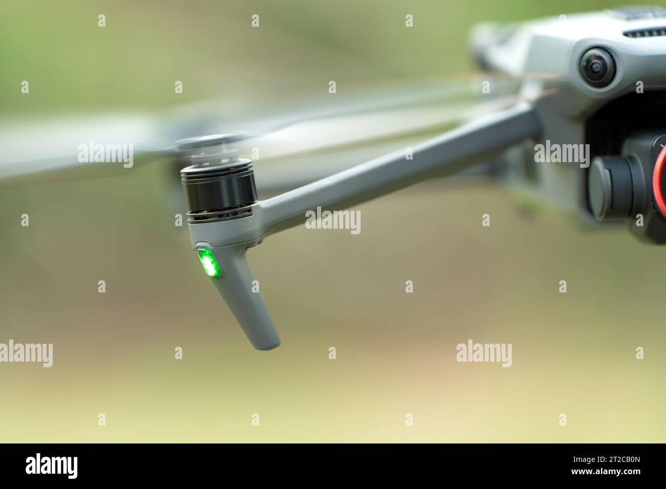 Drone aircraft with blurred fast rotating propellers and video camera ...