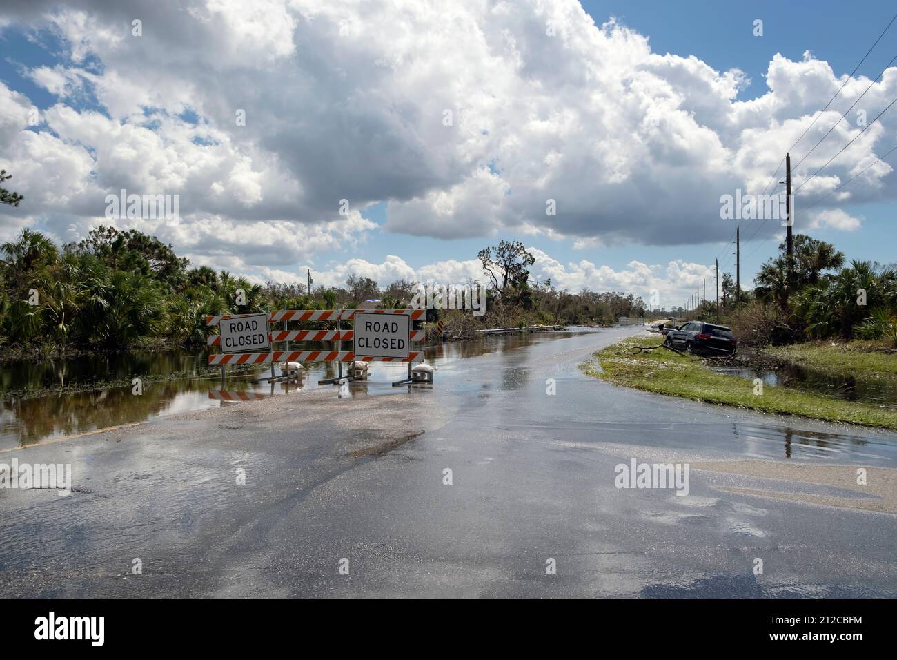 Hurricane flooded street with road closed signs blocking driving of ...