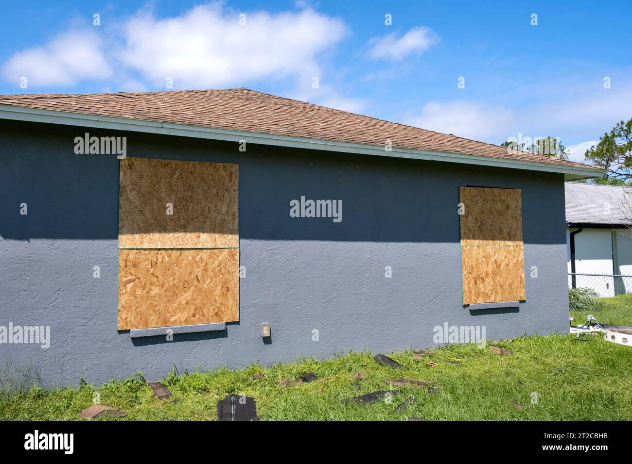 Hurricane shutters made from plywood mounted for protection of house ...