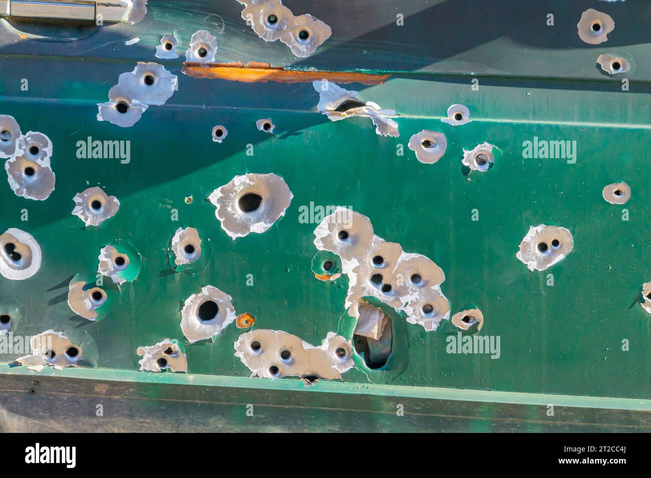 bullet holes in the metal. multiple bullet marks on the car body ...