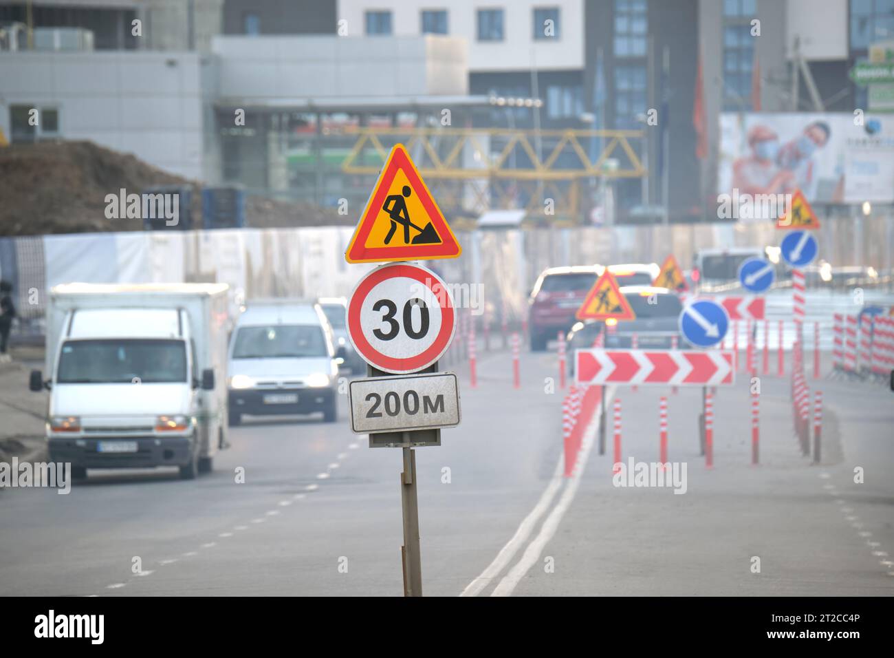 Roadworks warning traffic signs of construction work on city street and ...