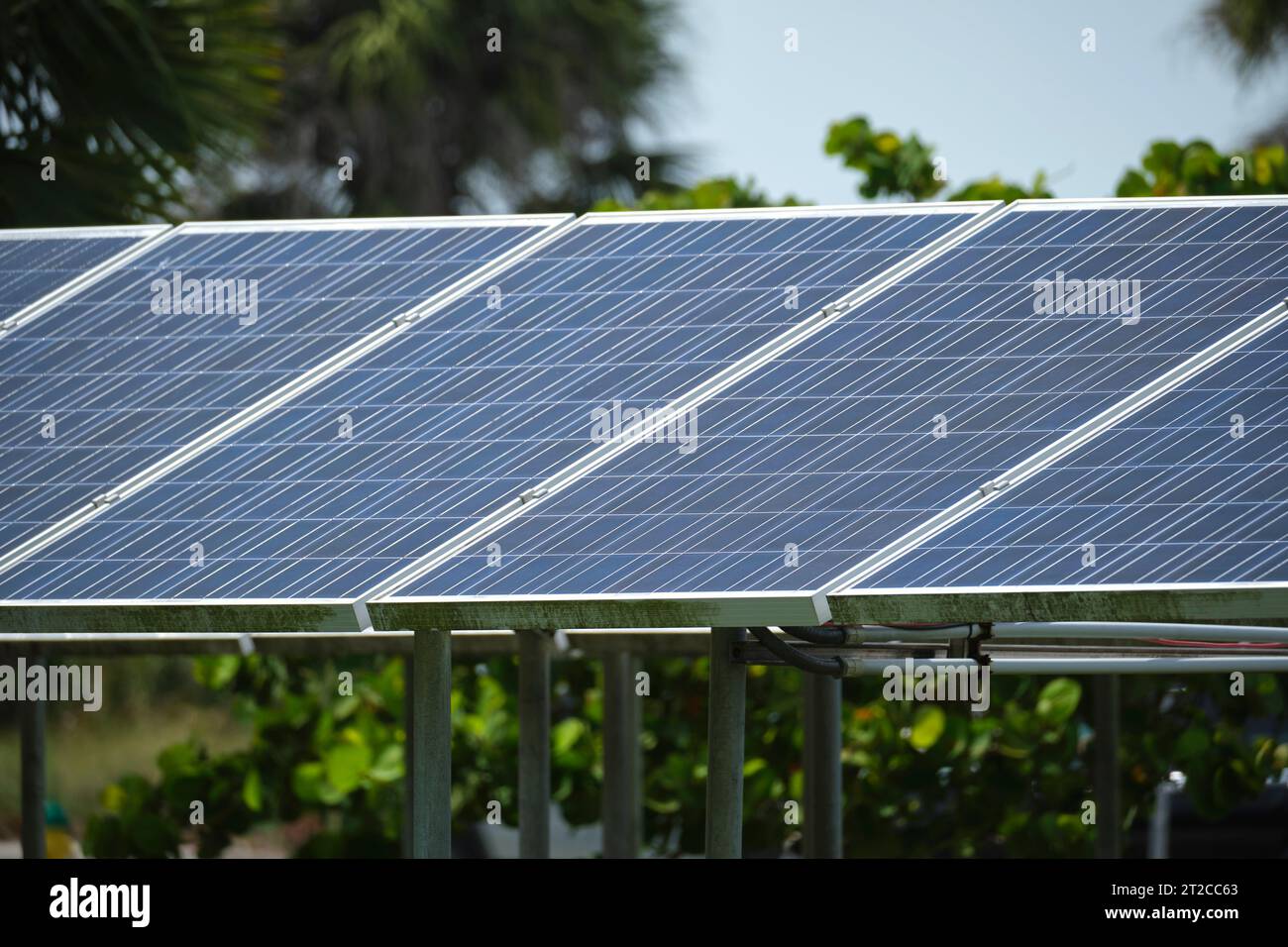 Solar panels installed on stand frame near parking lot for effective ...