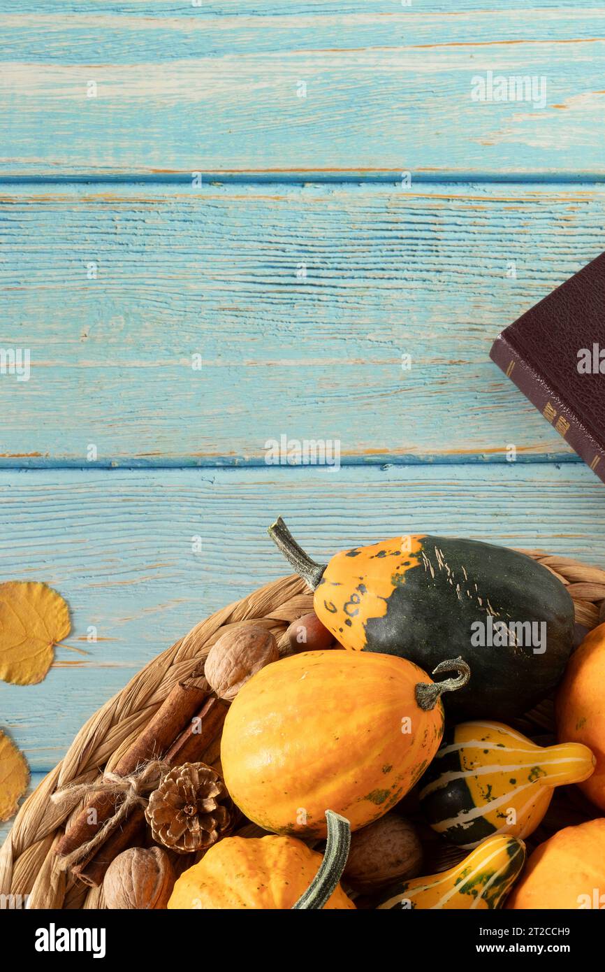Autumn fruit, nuts, leaves, and holy bible on wooden table. Vertical ...