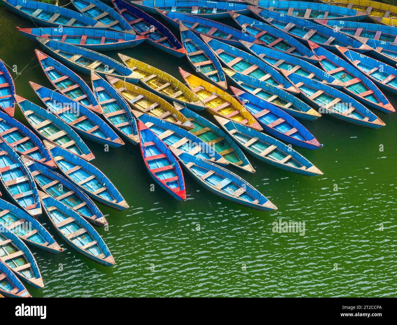 Aerial view of typical Nepalese boats moored along the lake shores of ...