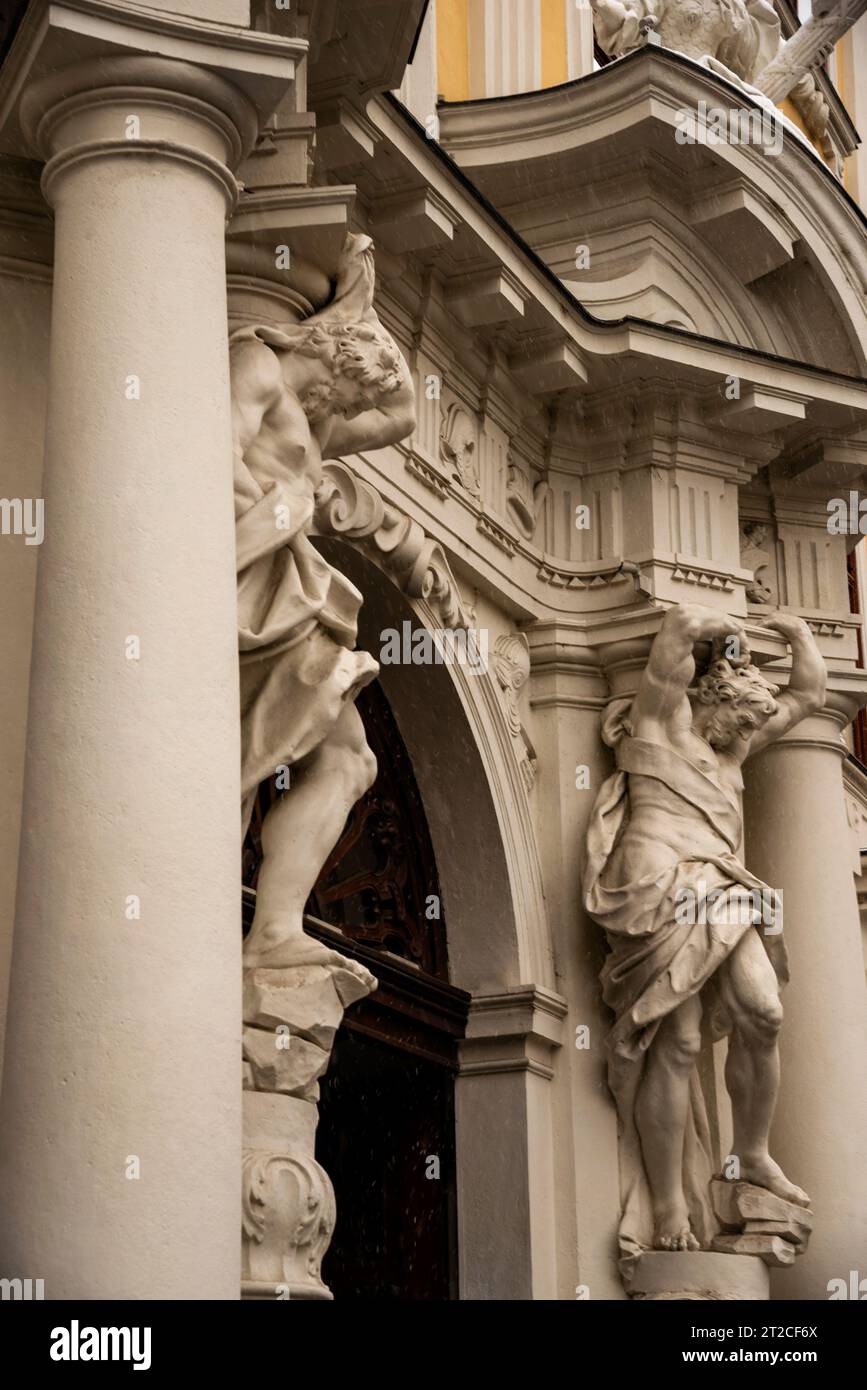 Atlas holding broken pediment under a light snow at Baroque Kinsky ...