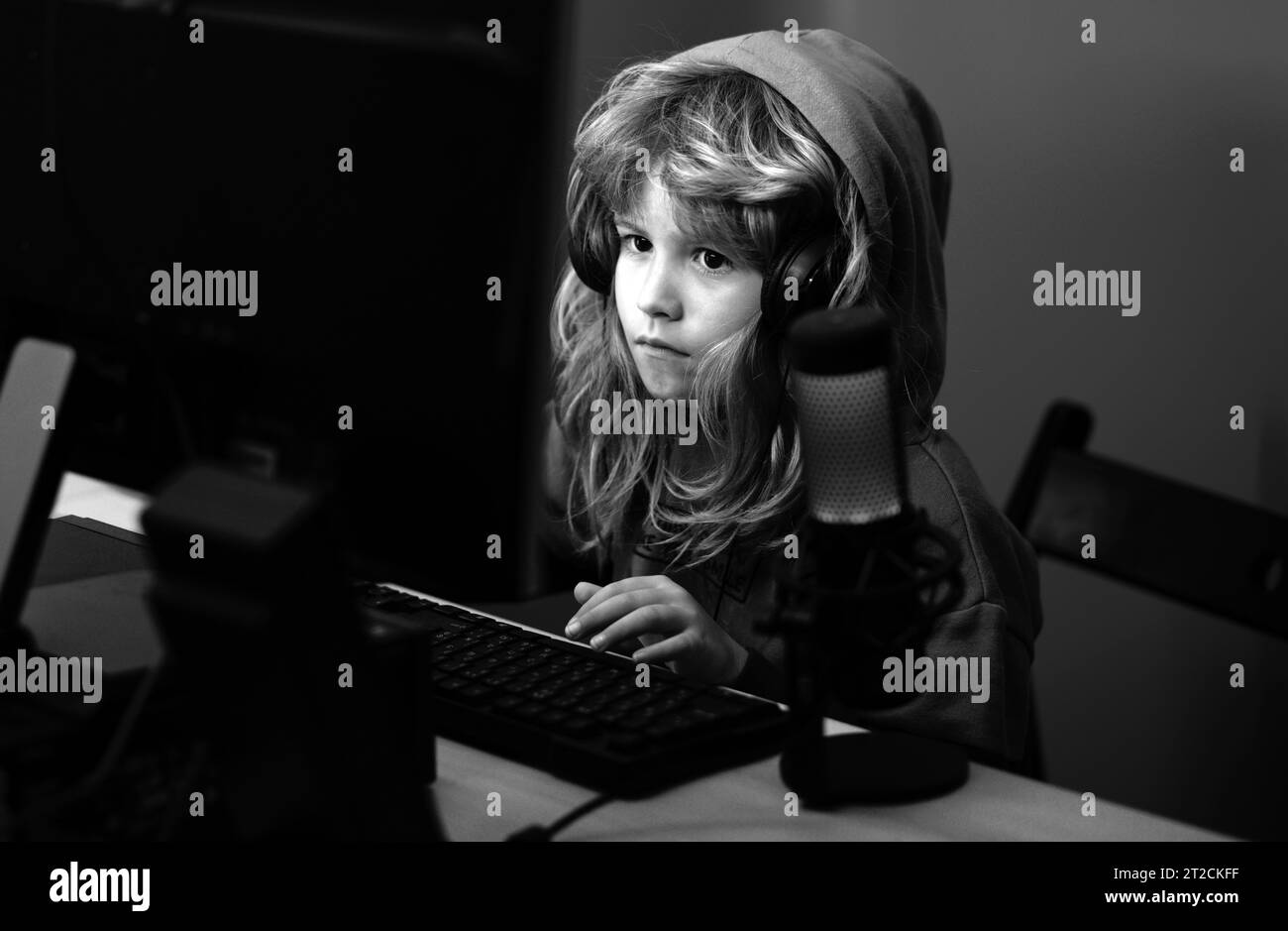 Little child gamer play computer game on desktop. Gaming stream and ...