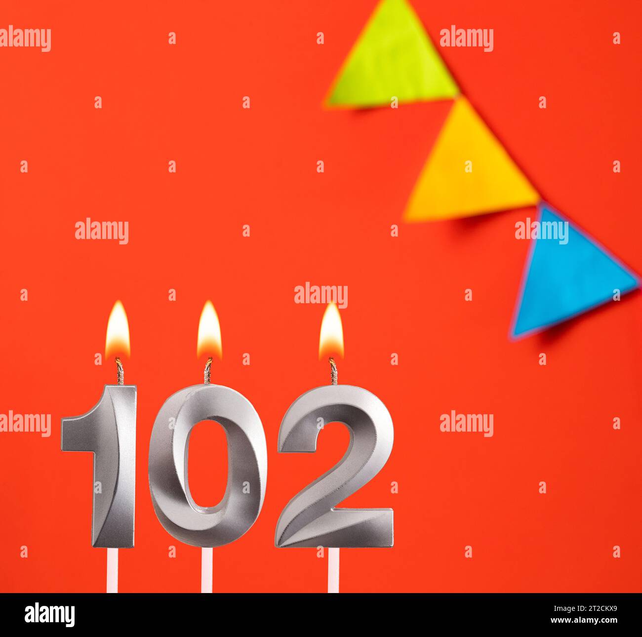 Birthday card - Number 102 candle in orange background Stock Photo - Alamy