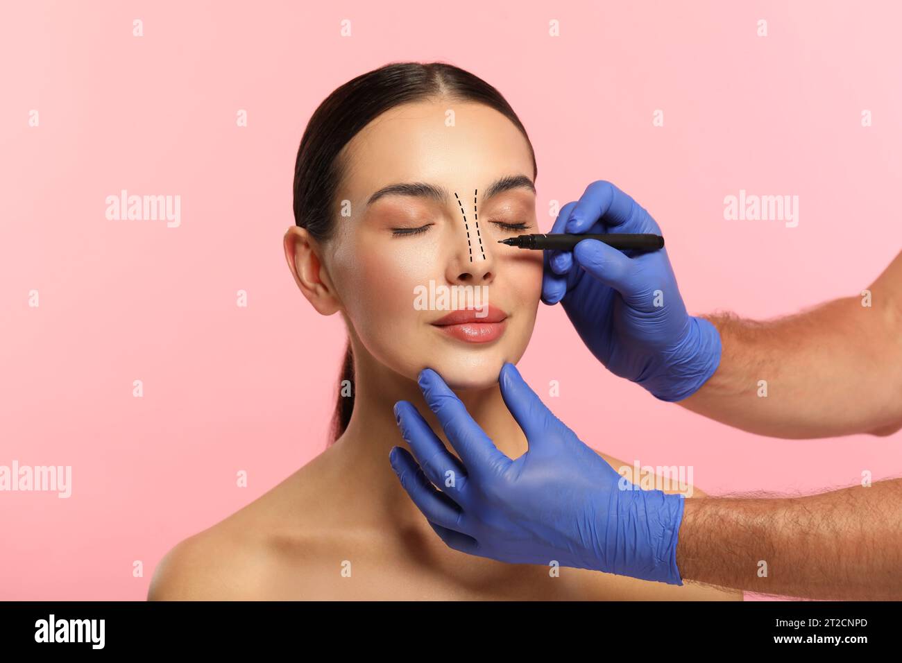 Woman preparing for cosmetic surgery, pink background. Doctor drawing ...
