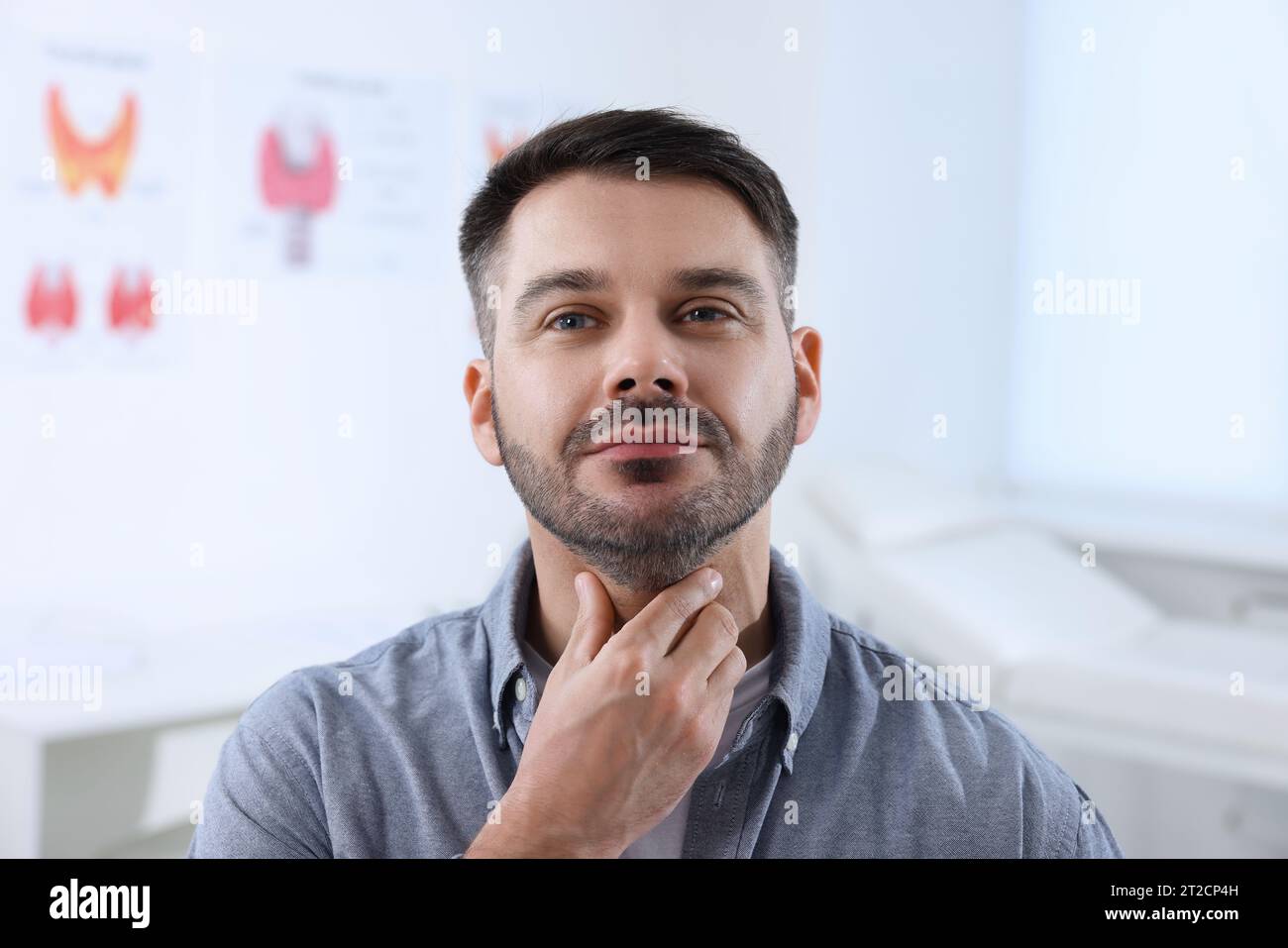 Endocrine system. Man doing thyroid self examination indoors Stock ...