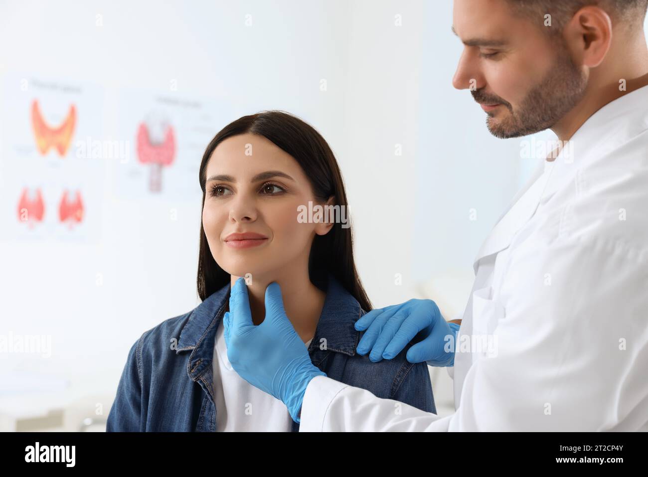 Endocrinologist examining thyroid gland of patient at hospital Stock ...