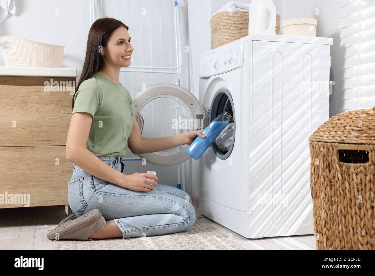 Woman pouring fabric softener washing hi-res stock photography and ...