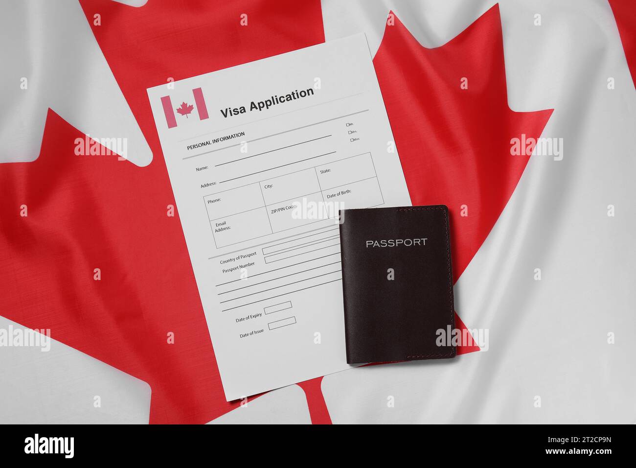 Immigration to Canada. Visa application form and passport on flag, flat ...