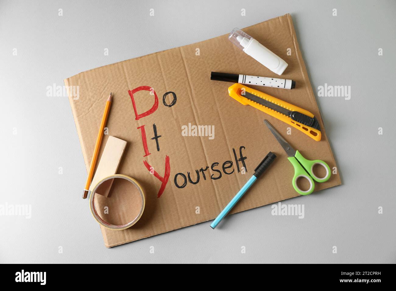 Cardboard sheet with written phrase Do It Yourself and stationery on ...
