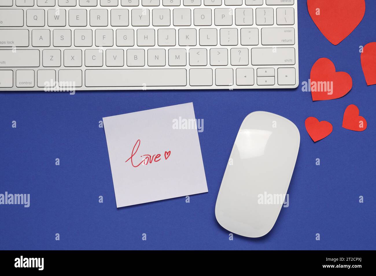 Long-distance relationship concept. Computer mouse, keyboard, love note ...