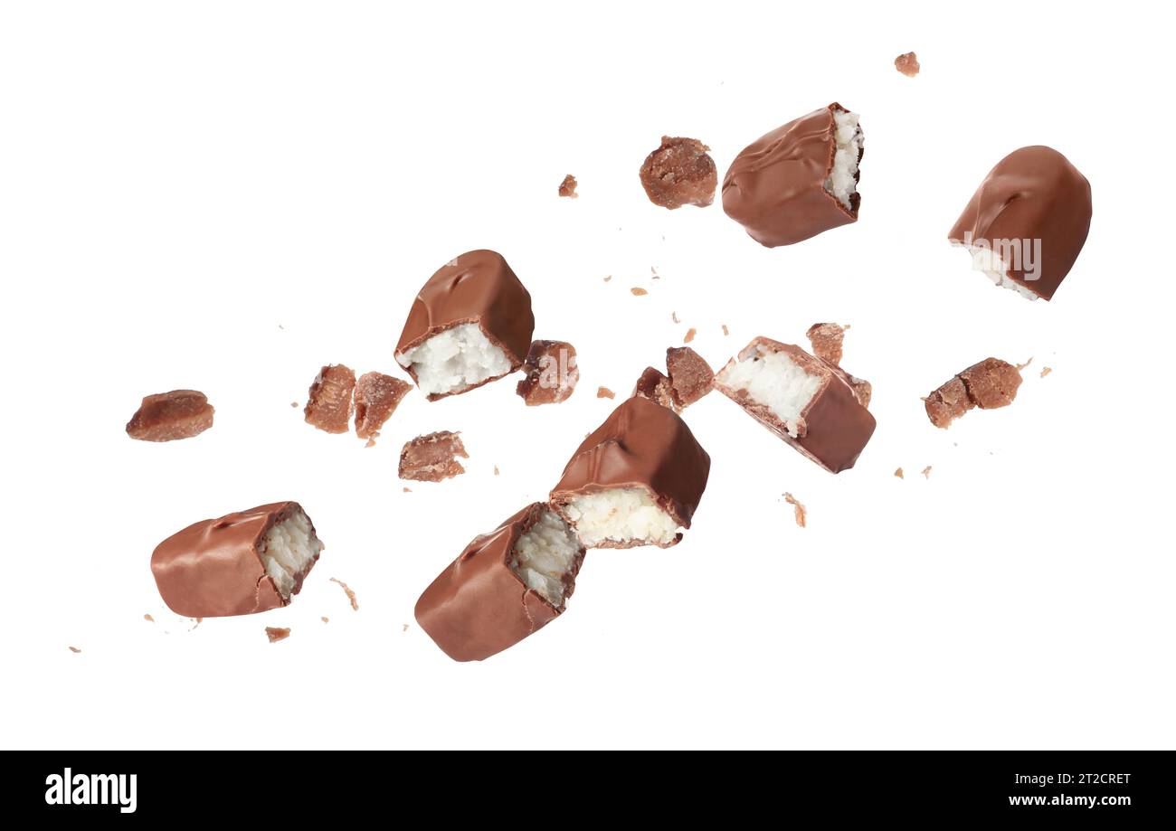 Pieces of delicious chocolate bars with coconut filling falling on ...