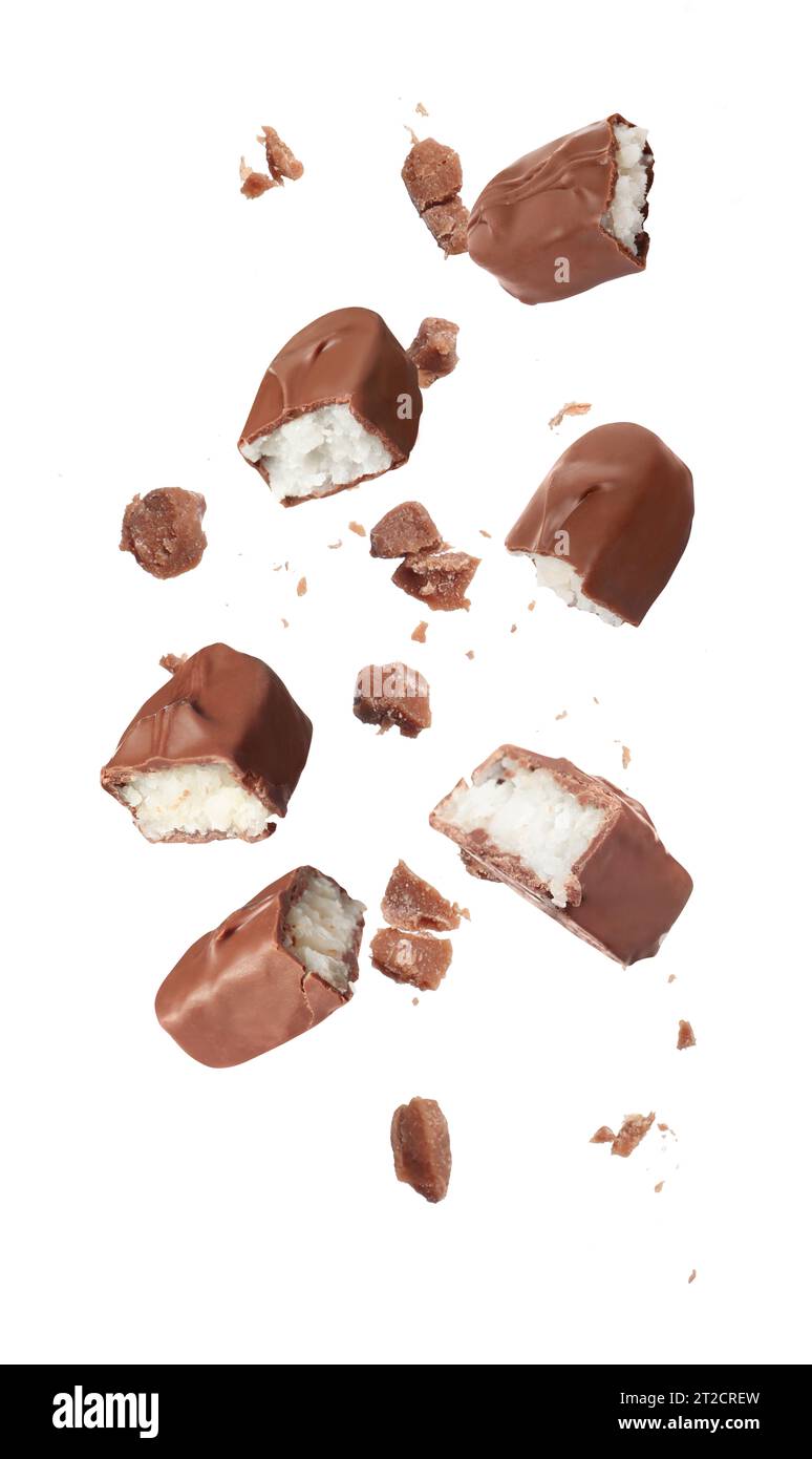 Pieces of delicious chocolate bars with coconut filling falling on ...