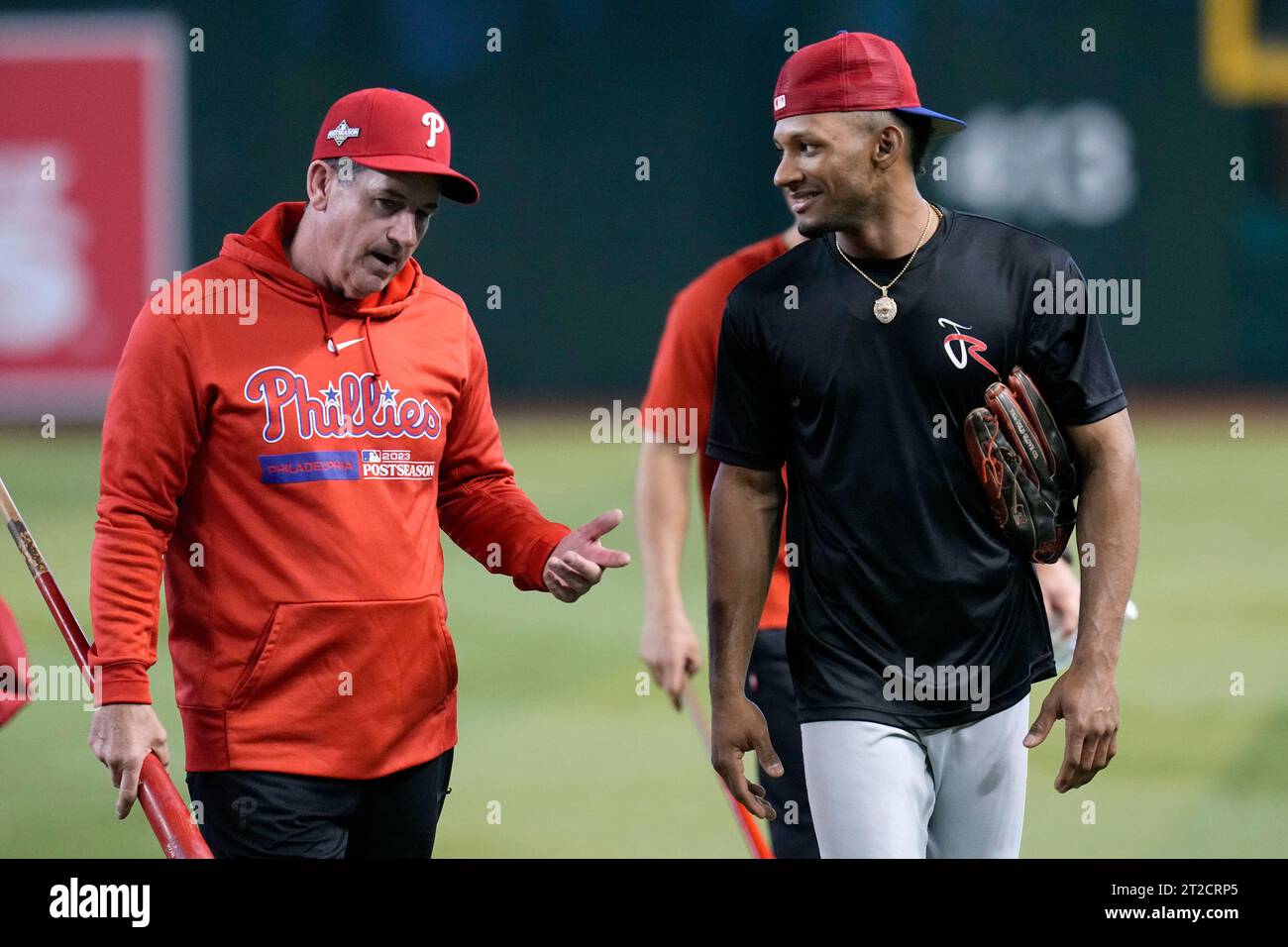 Philadelphia Phillies manager Rob Thomson, left, talks with Johan Rojas ...