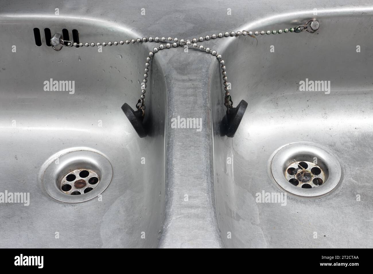 A pair of kitchen sinks with stoppers on a chains Stock Photo - Alamy