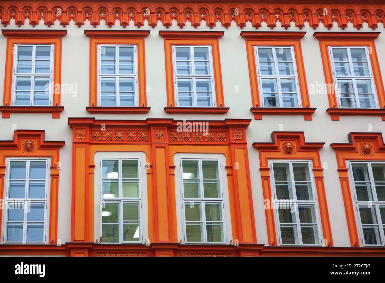 Colorful windows with stucco on the facade of an old house Stock Photo ...