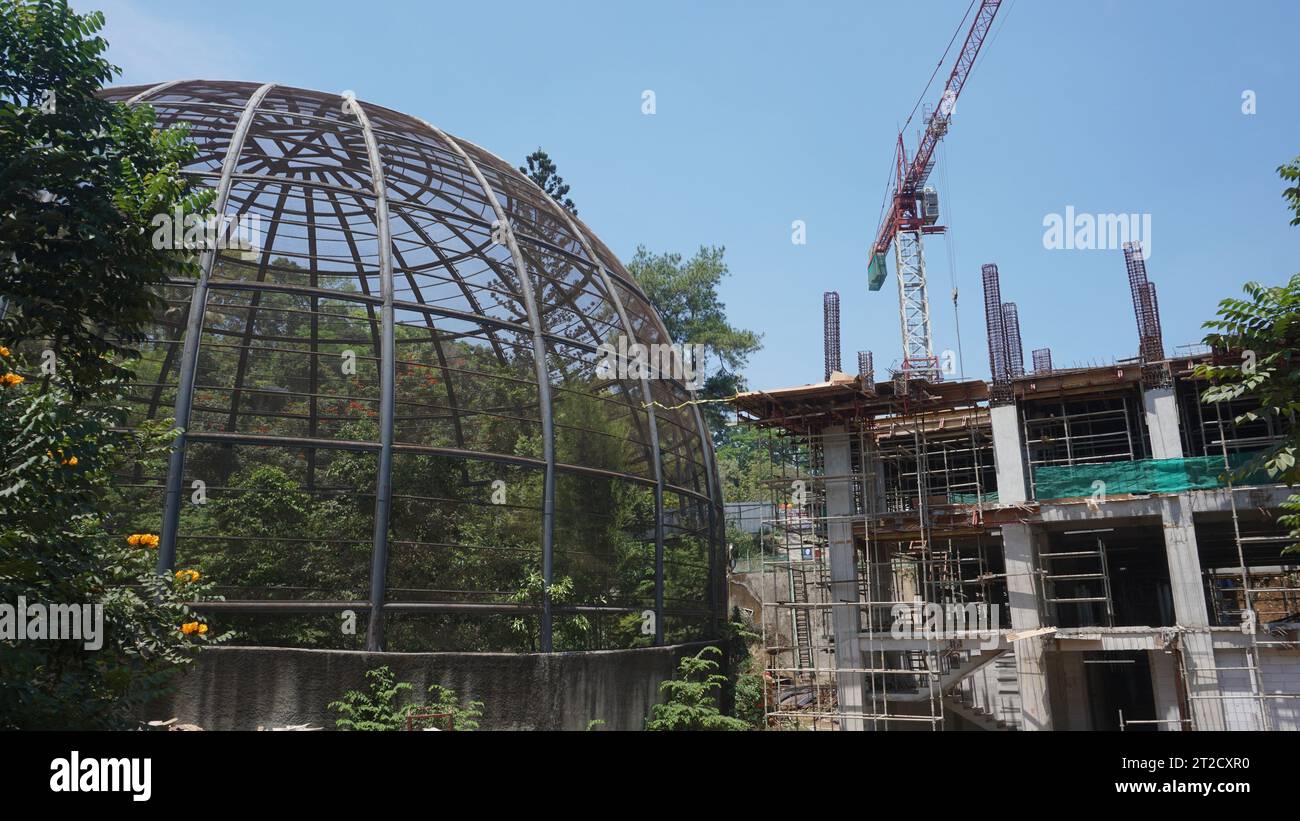 Large metal dome aviary for bird conservation next to a building ...
