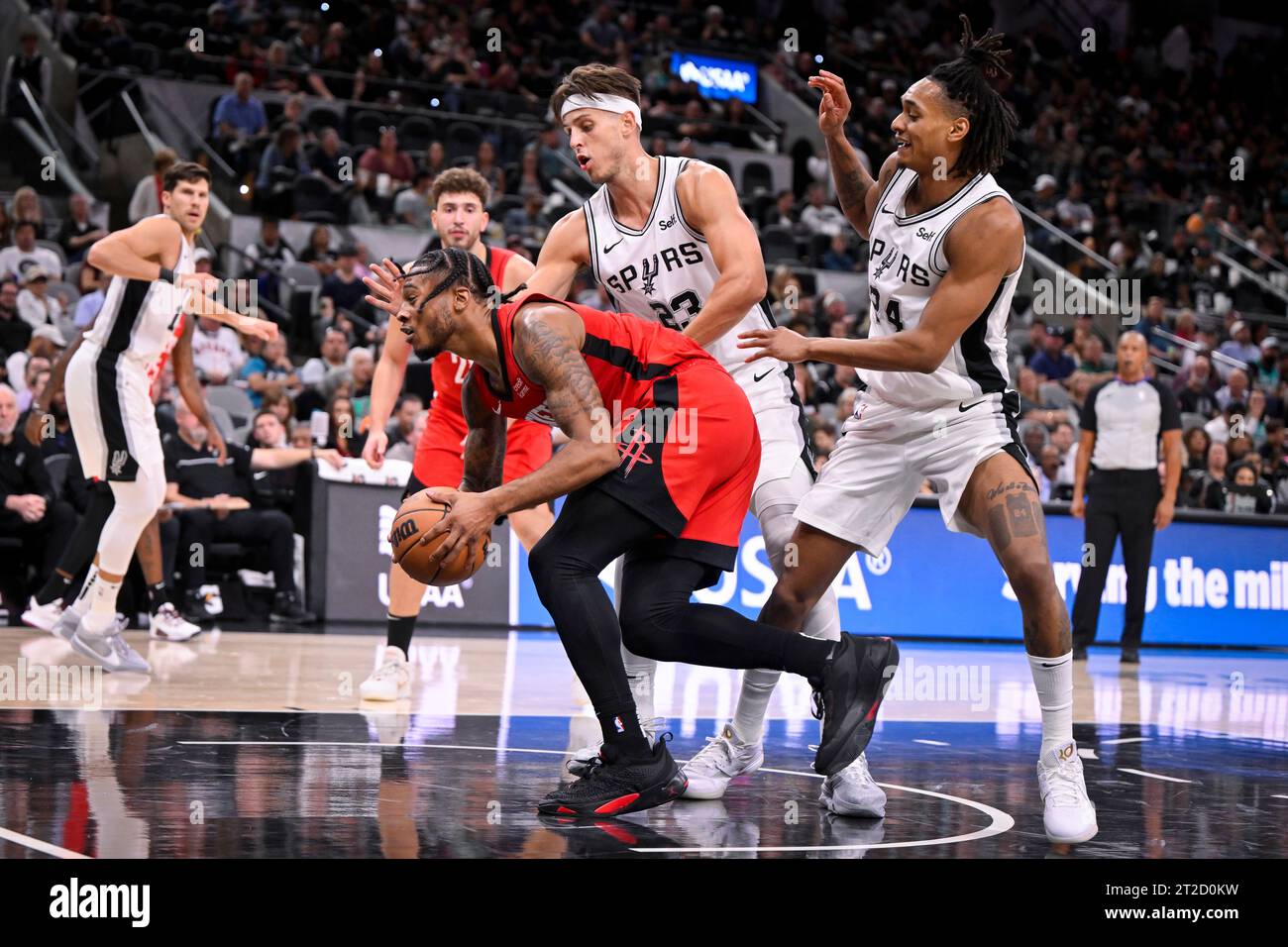 Houston Rockets' Cam Whitmore, center, is fouled as he drives to the ...