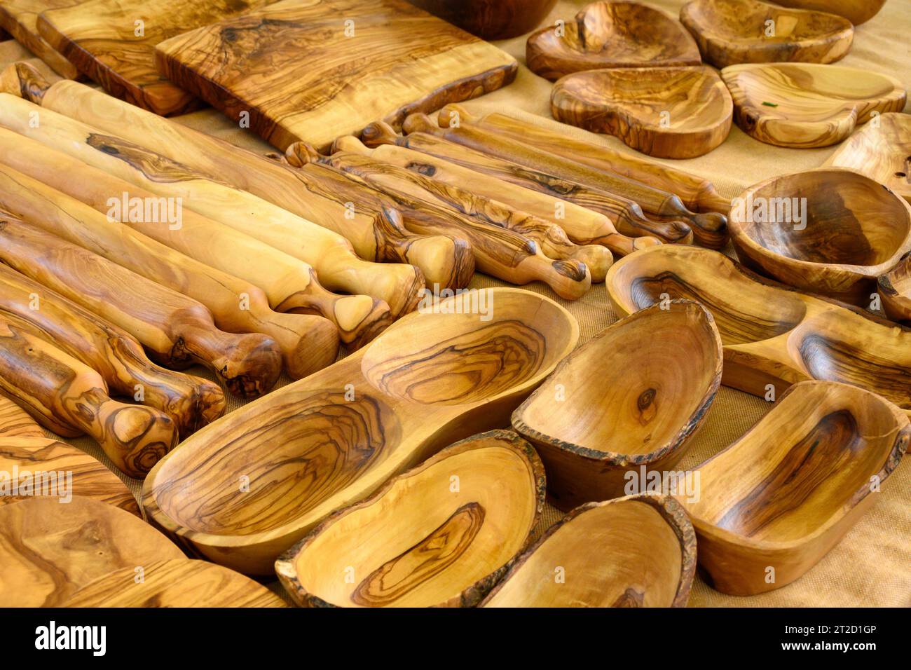 Craft works on table, olive tree wooden kitchen utensils on weekly ...