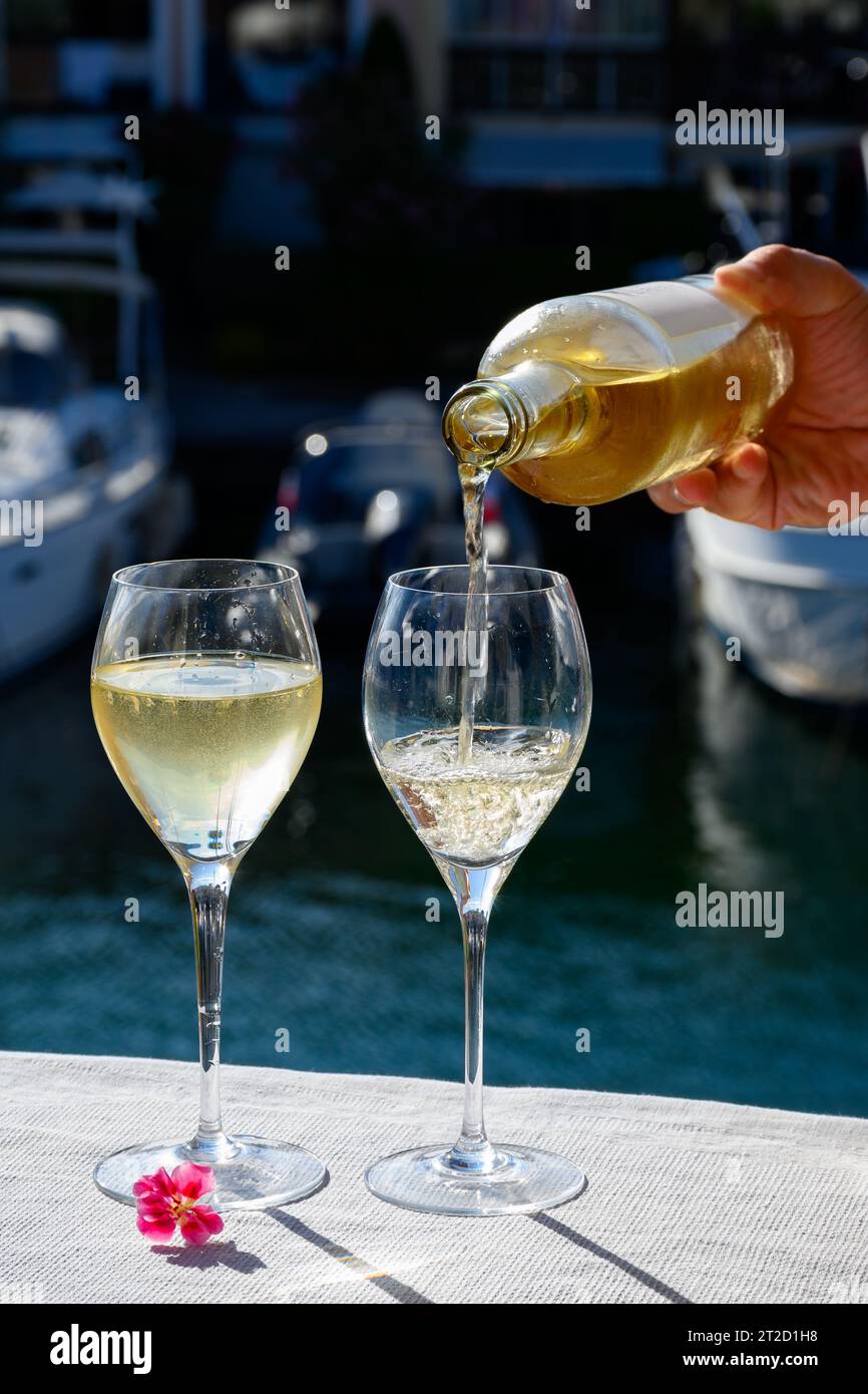 Glass of cold white wine in yacht harbour of Port Grimaud, summer ...