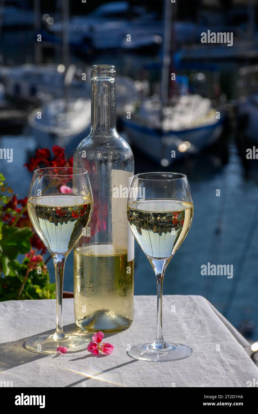 Glass of cold white wine in yacht harbour of Port Grimaud, summer ...