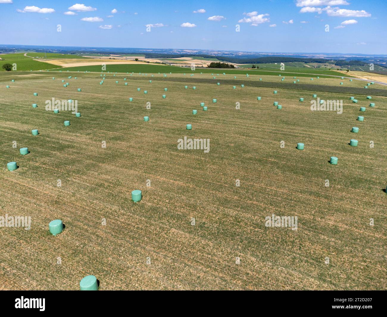 Aerial view, agriculture in France, yellow haystacks on golden wheat ...