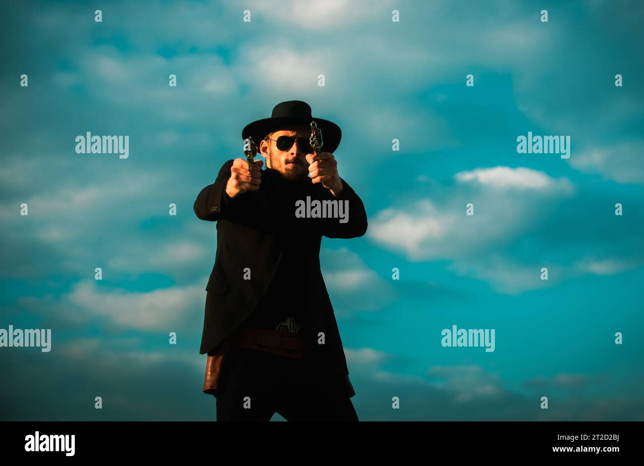 Sheriff or cowboy in black suit with vintage pistol revolver and ...