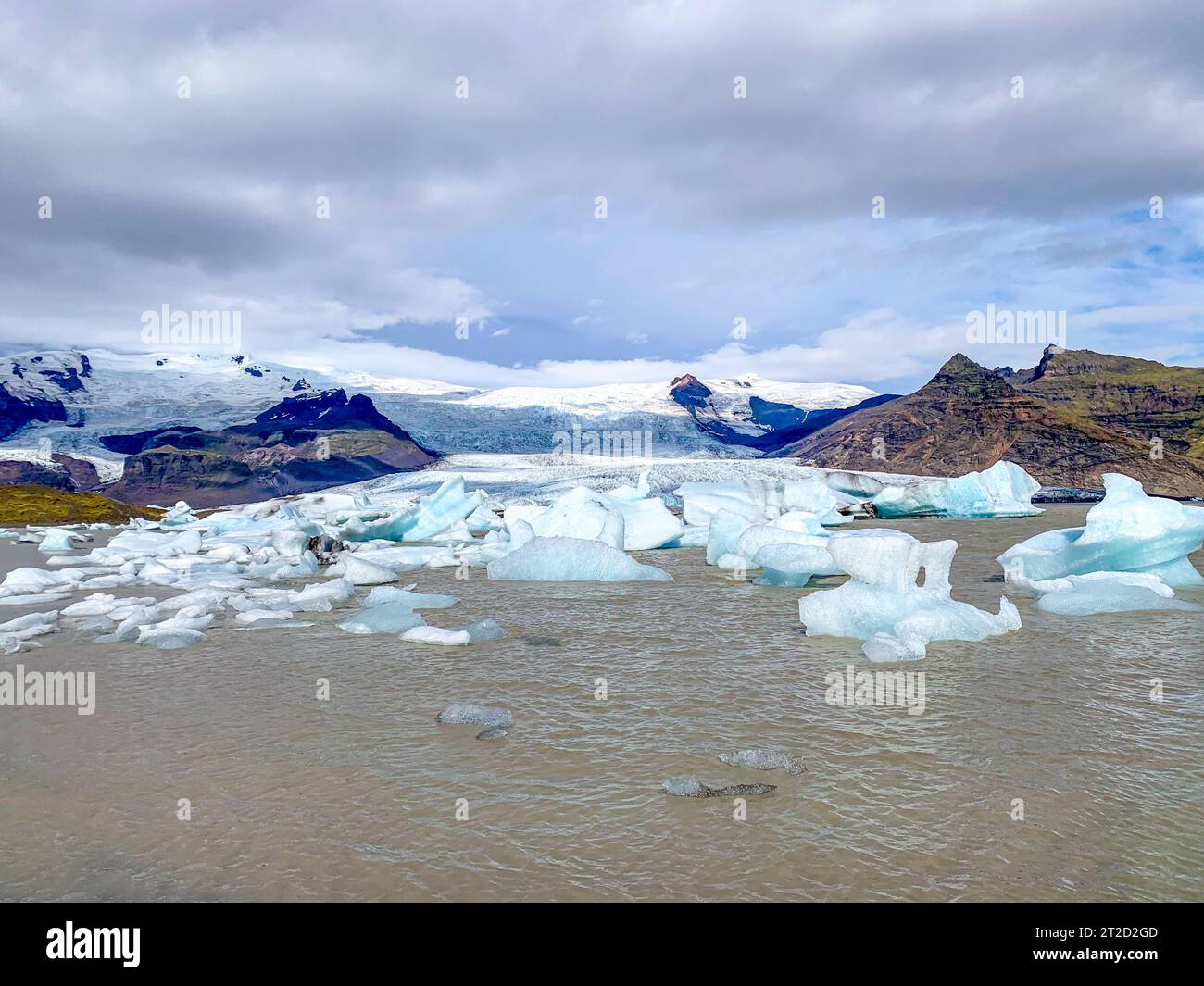 cloudy sky and small iceberg floating on the lake at scenic Fjallsarlon ...