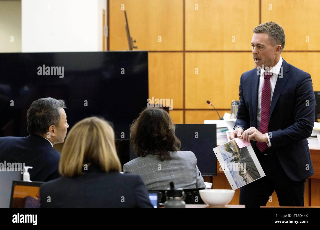 Defense attorney Casey Arbenz, right, shows prosecuting attorneys, left ...