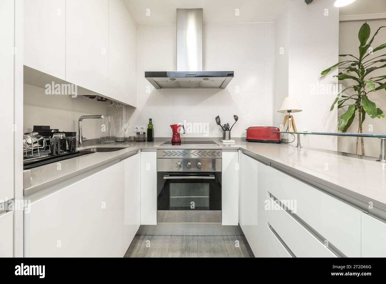 Open kitchen of a loft-style apartment with bright white furniture ...