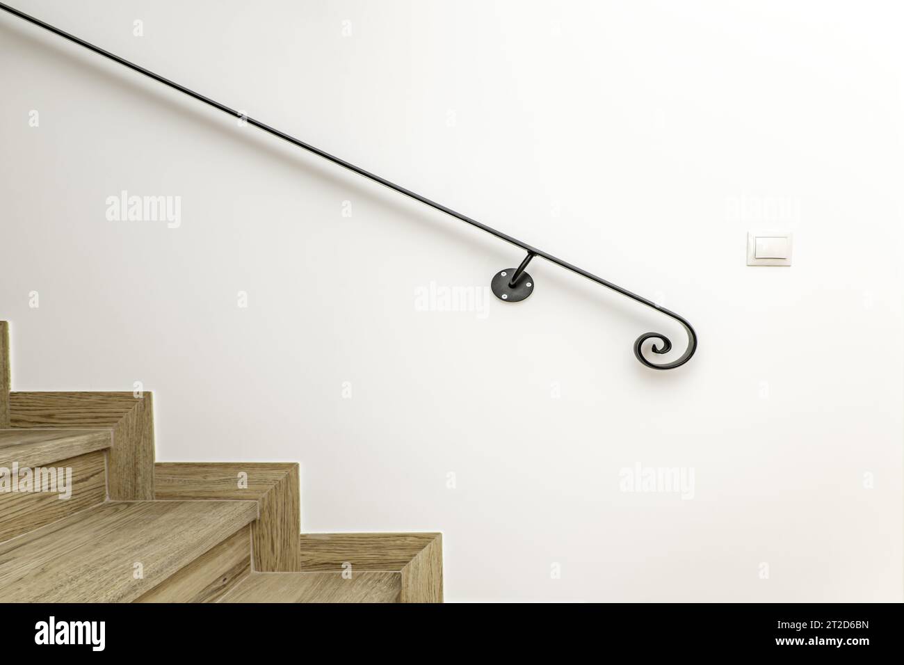 Black metal handrail attached to a white wall Stock Photo - Alamy